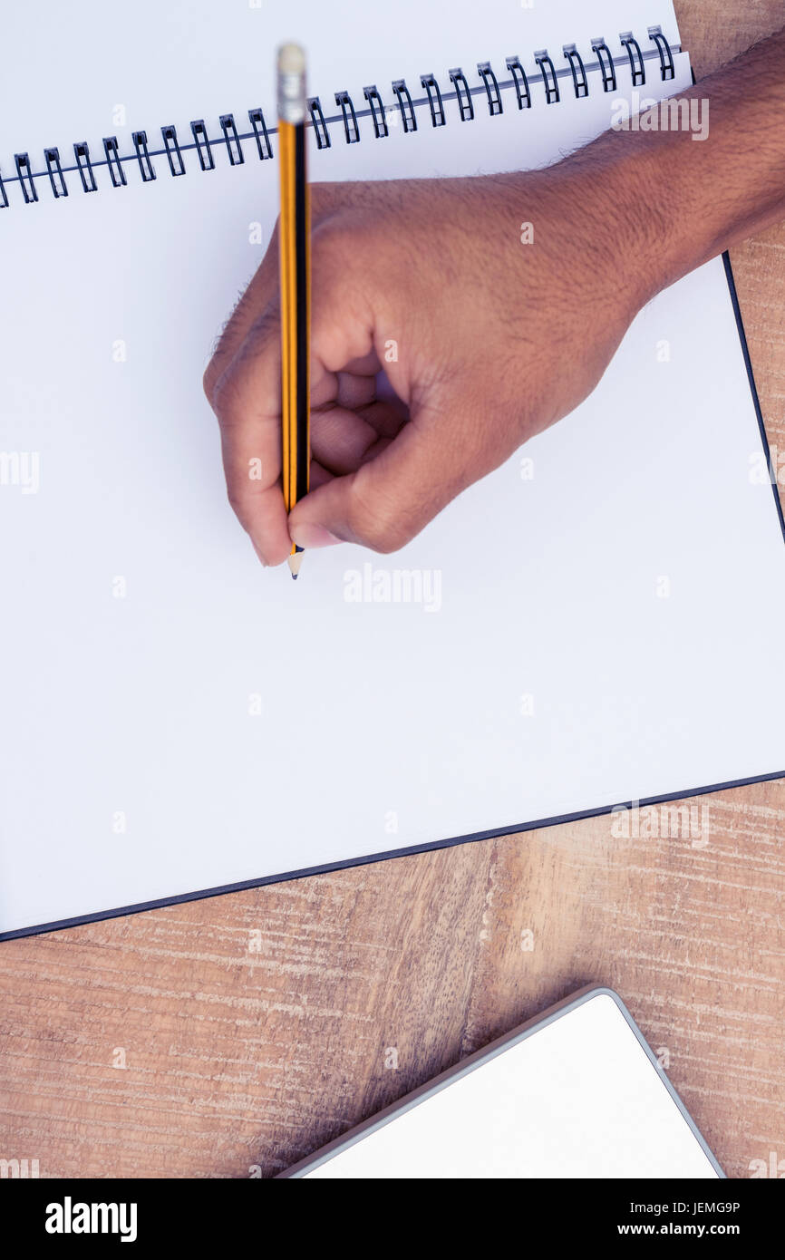 Businessman writing on book Stock Photo - Alamy