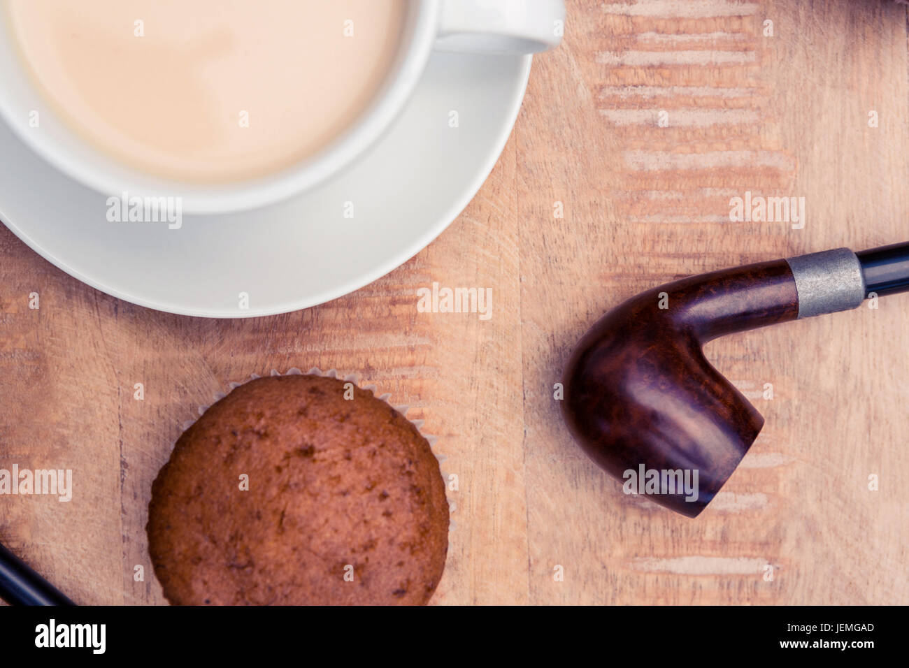 Coffee with muffin and smoking pipe Stock Photo - Alamy