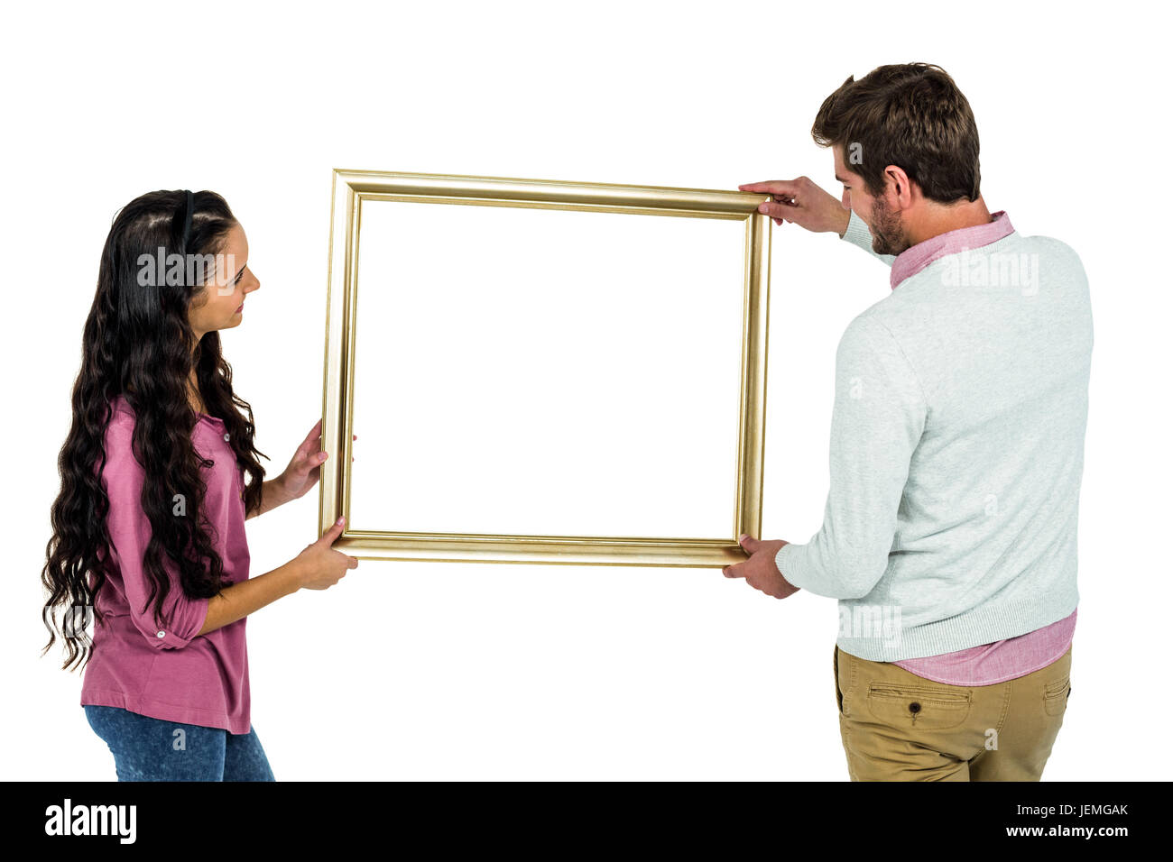 Smiling couple holding picture frame Stock Photo - Alamy