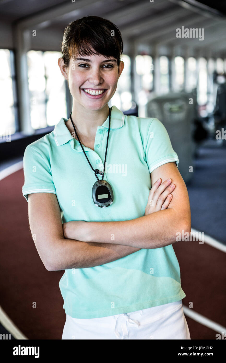 Smiling trainer with arms crossed Stock Photo - Alamy