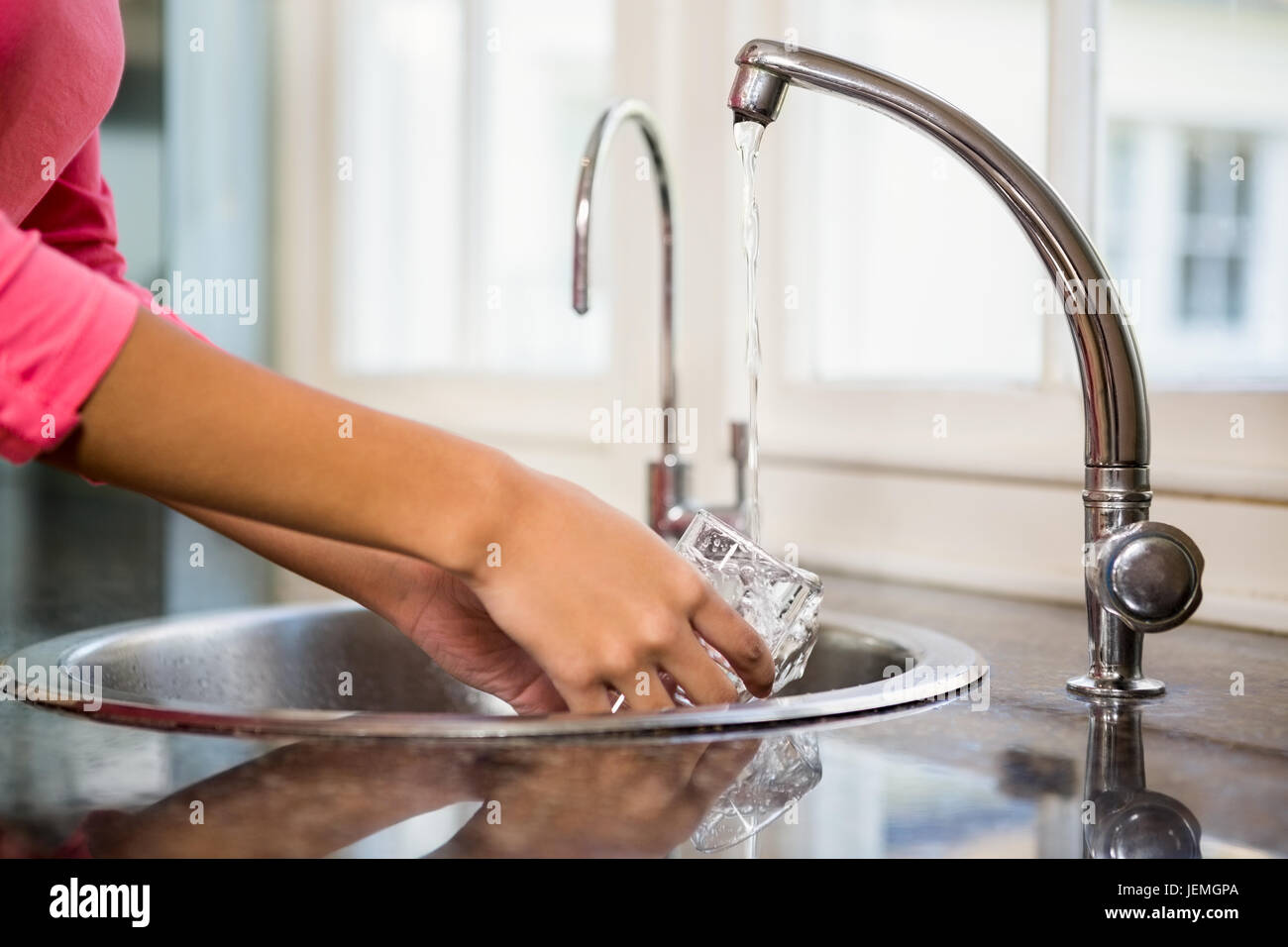 Pretty young woman washing up hi-res stock photography and images - Alamy