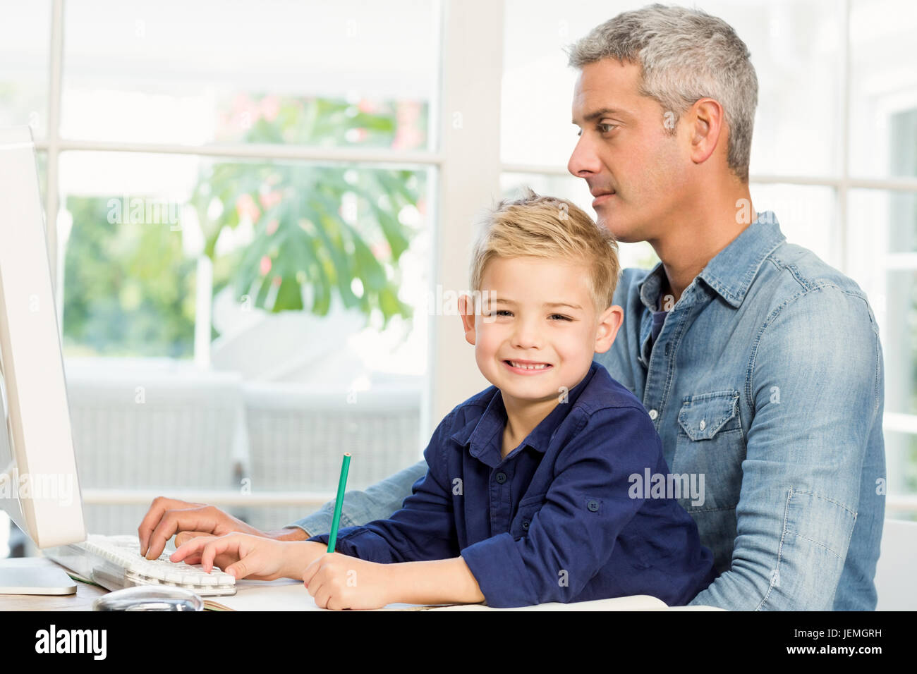 Father and son at the desk Stock Photo - Alamy