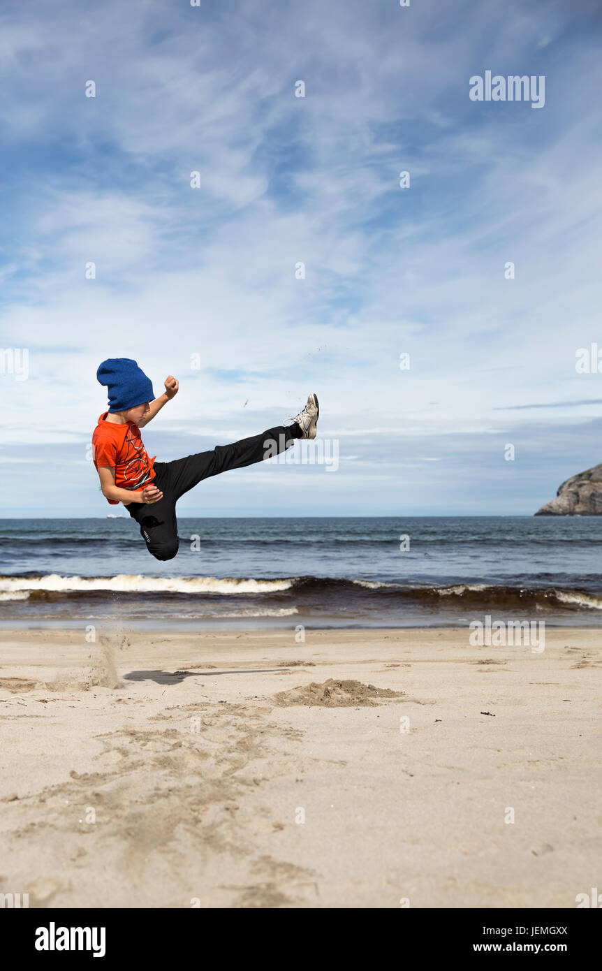 Boy jumping on beach Stock Photo - Alamy