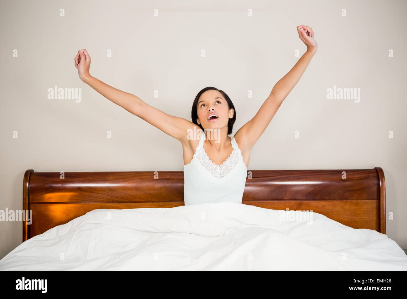 Attractive brunette waking up Stock Photo - Alamy
