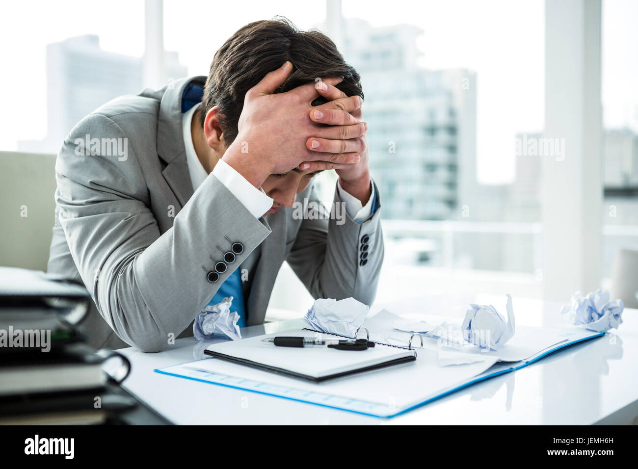 Businessman being depressed by working Stock Photo - Alamy