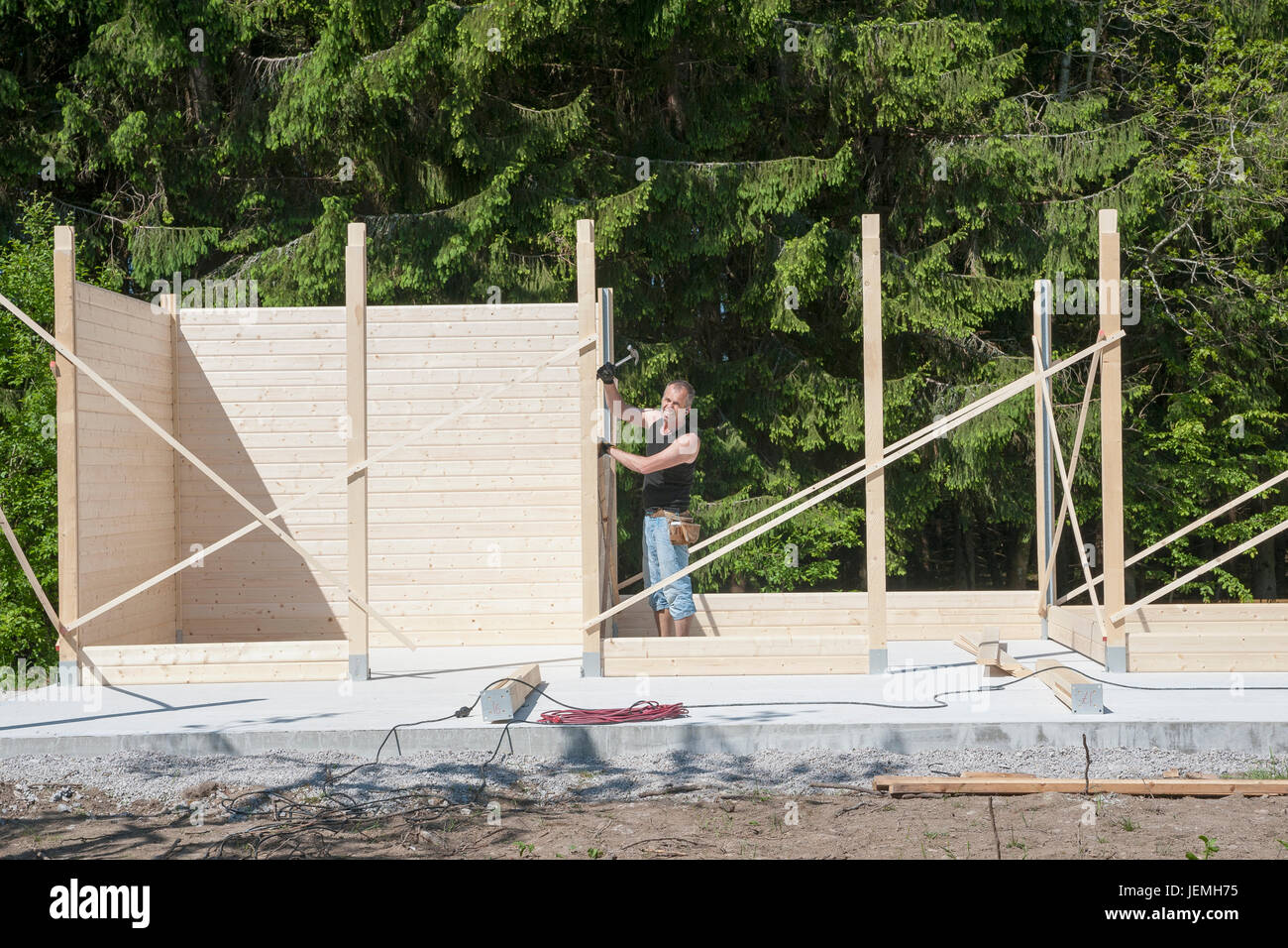 Man building house Stock Photo - Alamy