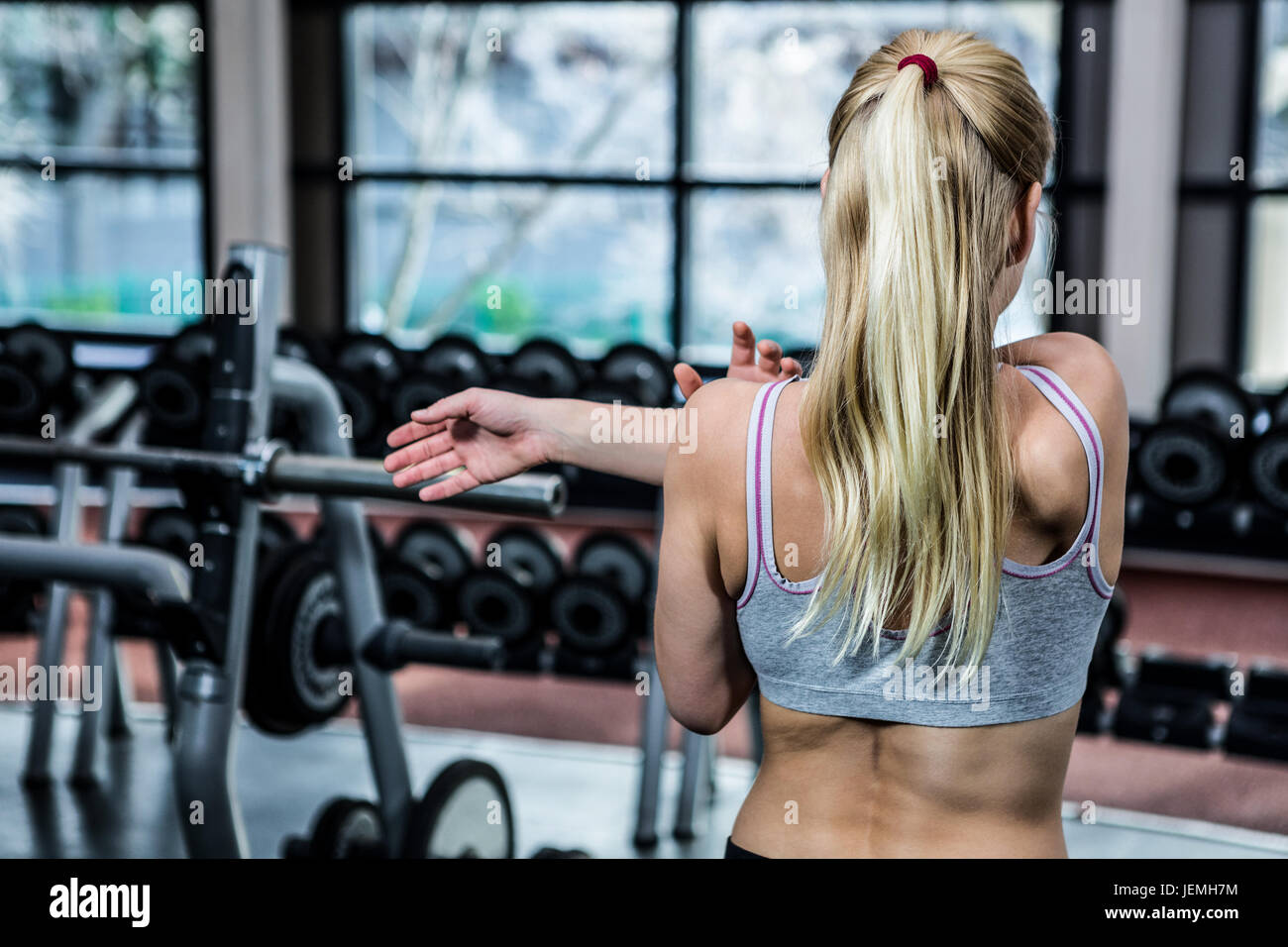Rear view of woman stretching arms Stock Photo - Alamy