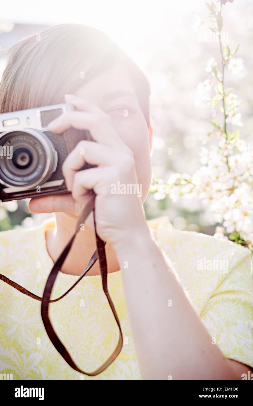 Young woman taking picture Stock Photo - Alamy