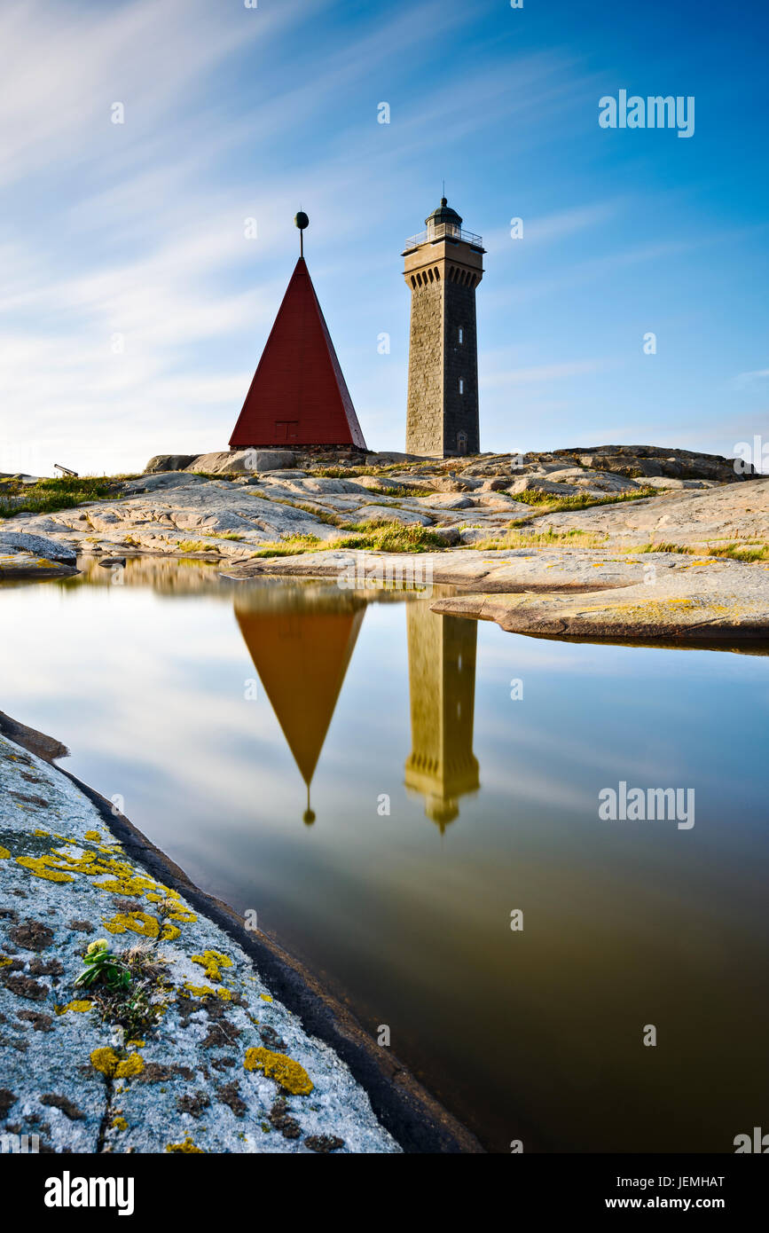 Lighthouse reflecting on water Stock Photo - Alamy