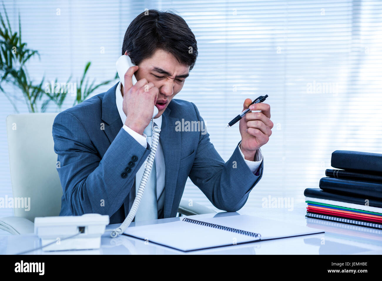 Angry asian businessman on phone hi-res stock photography and images ...