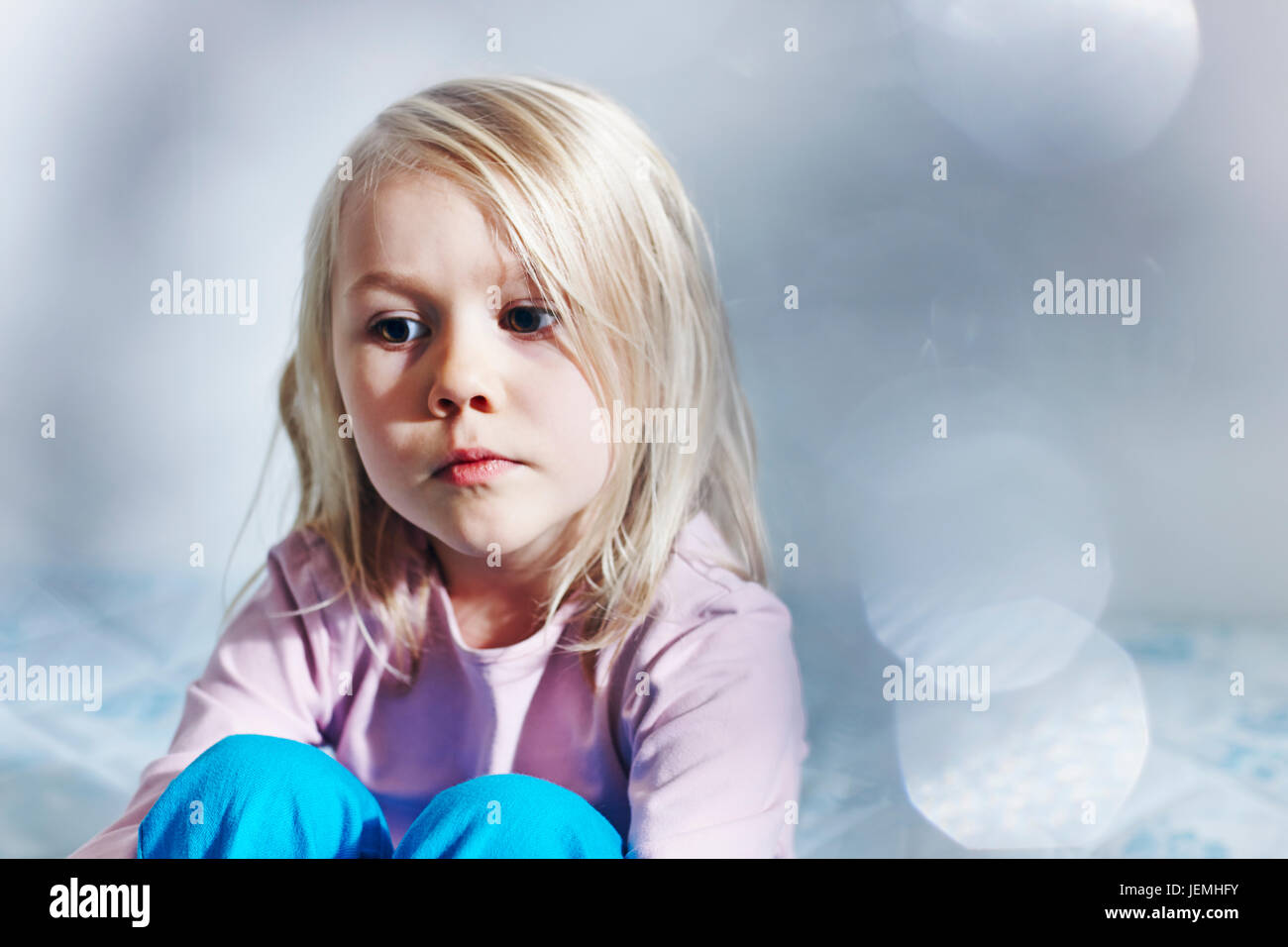 Sad girl looking away Stock Photo - Alamy
