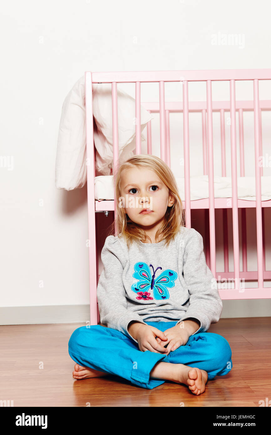 Girl sitting in room Stock Photo - Alamy