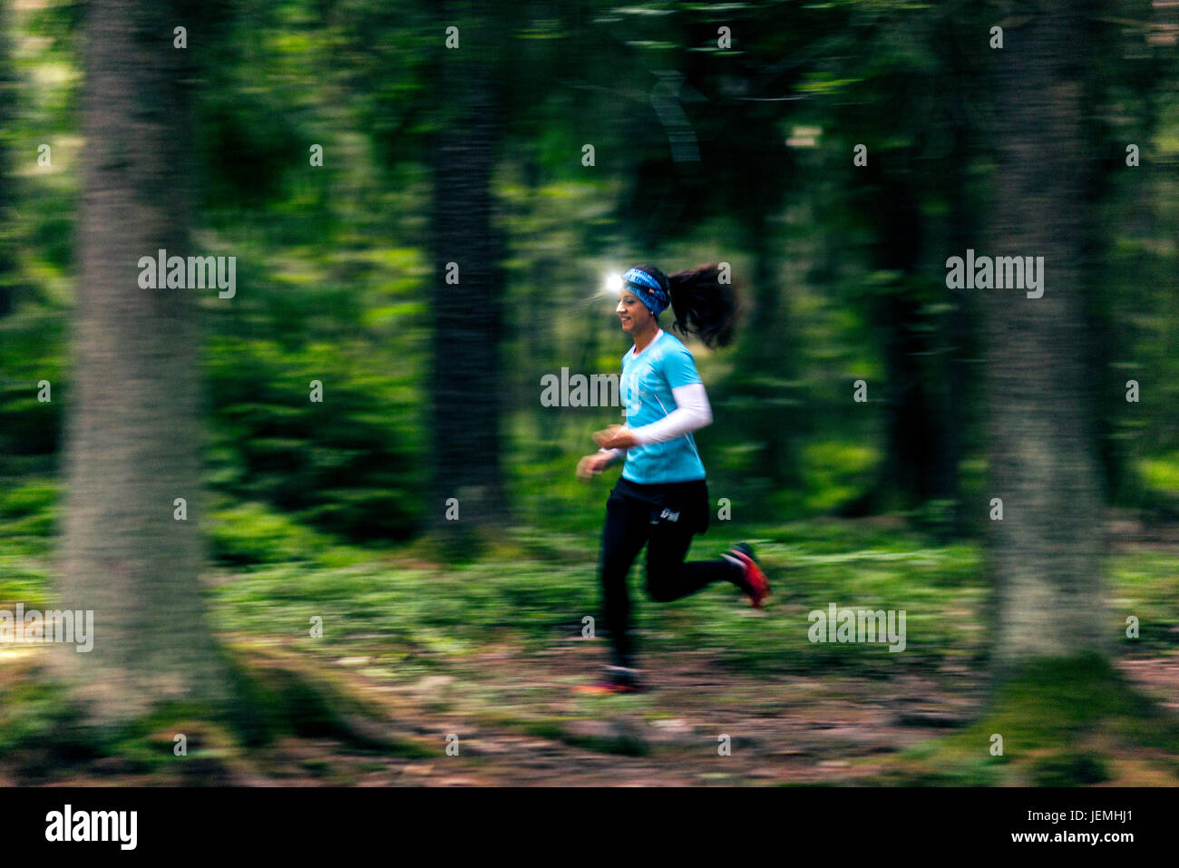 Woman running in forest Stock Photo - Alamy