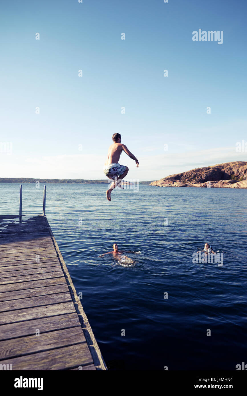 Man jumping into water Stock Photo - Alamy