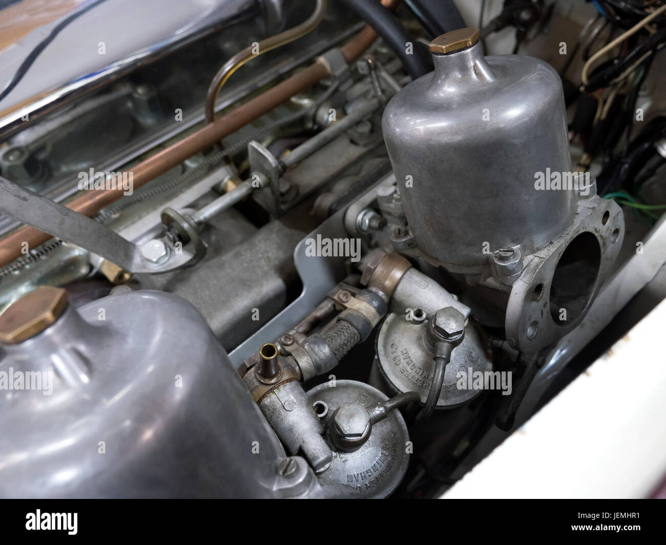 Classic car mechanics working on a car in their workshop Stock Photo ...
