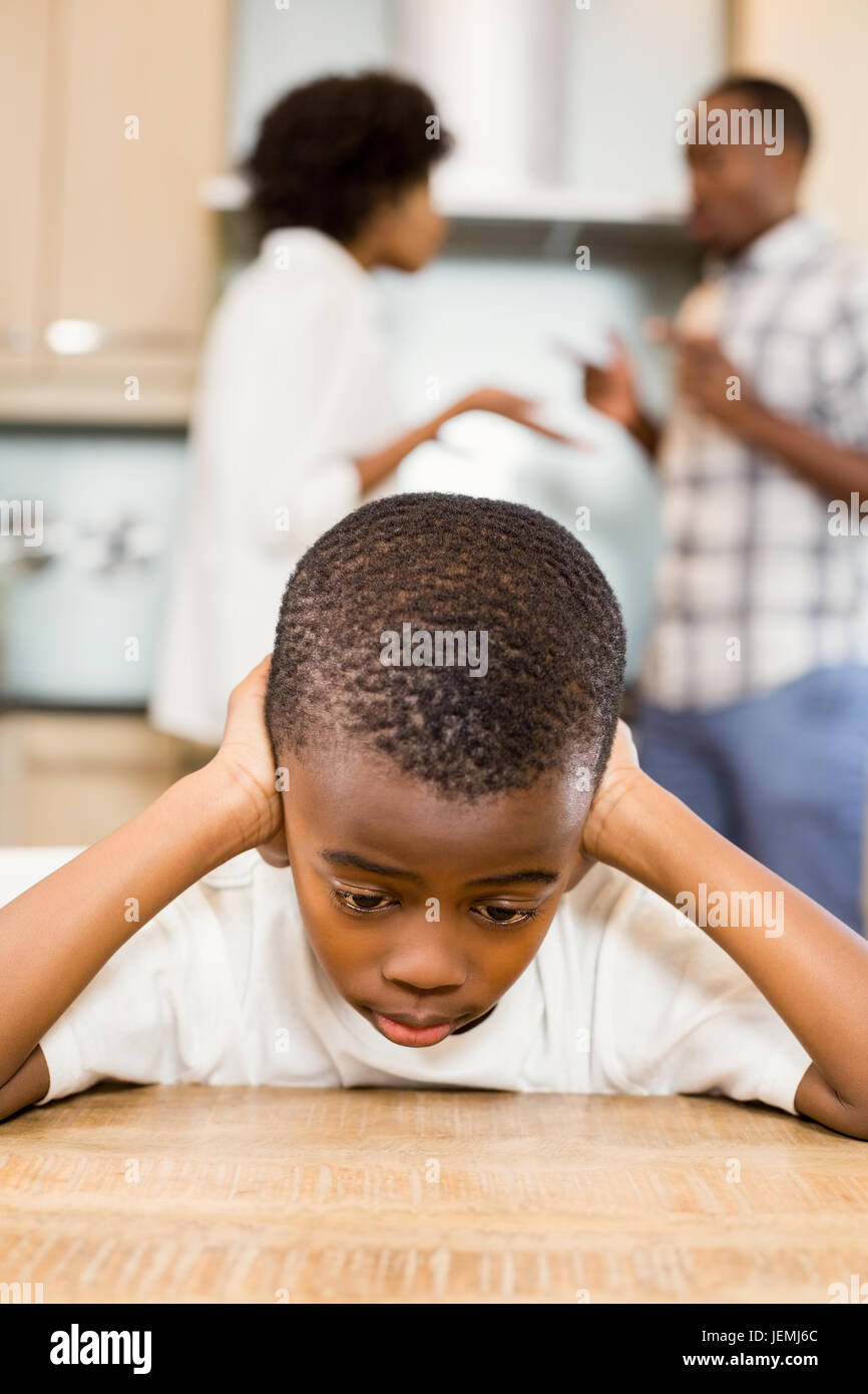 Sad boy against parents arguing Stock Photo - Alamy
