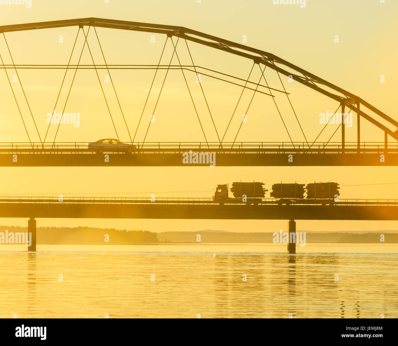Lorry driving through bridge at sunset Stock Photo - Alamy