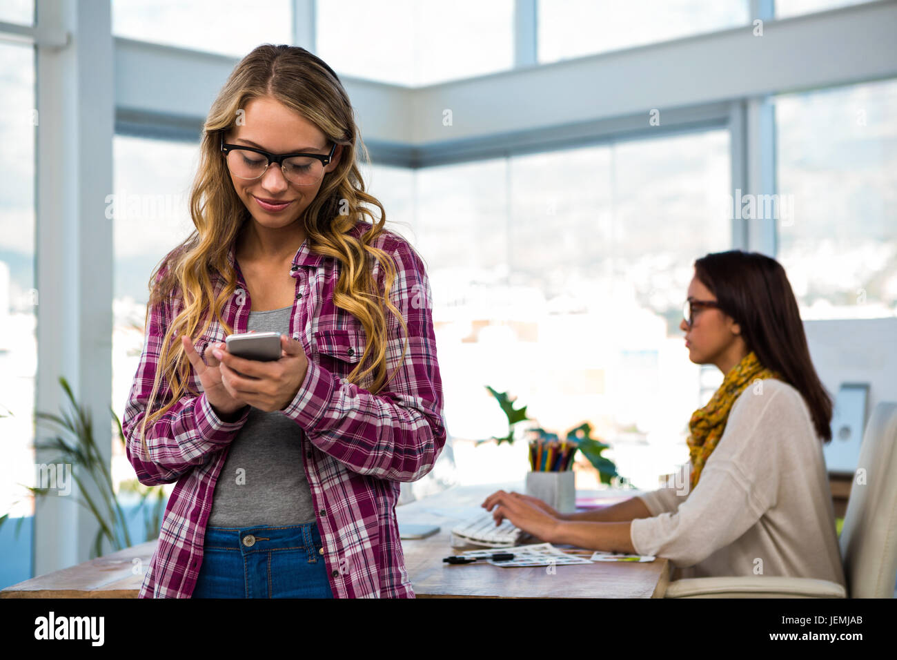 Two girls work at office Stock Photo - Alamy