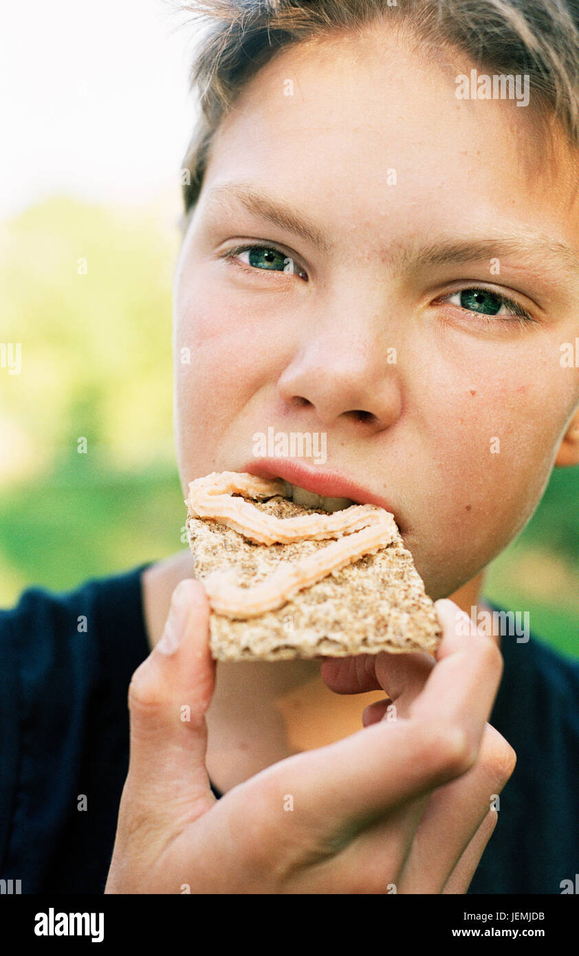 Boy eating crispbread Stock Photo - Alamy