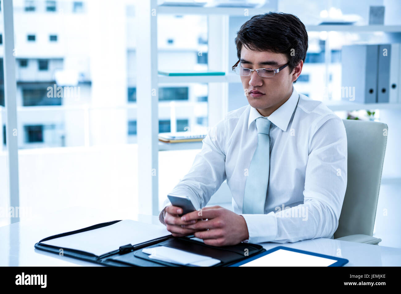 Focused asian professional holding phone hi-res stock photography and ...