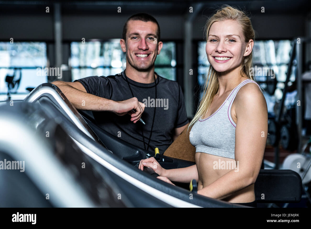 Fit woman with trainer using treadmill Stock Photo - Alamy
