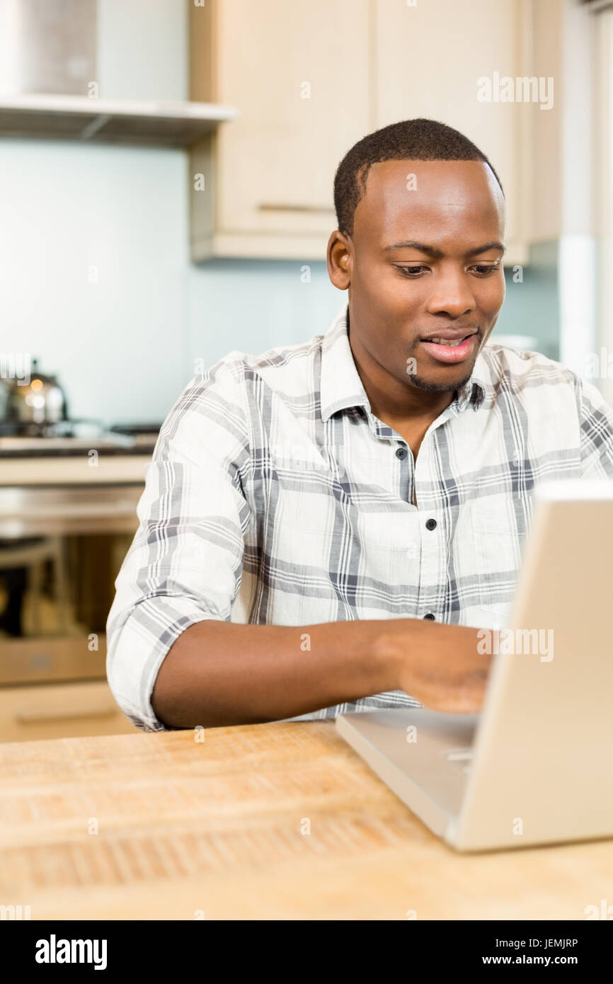Handsome man using laptop Stock Photo - Alamy