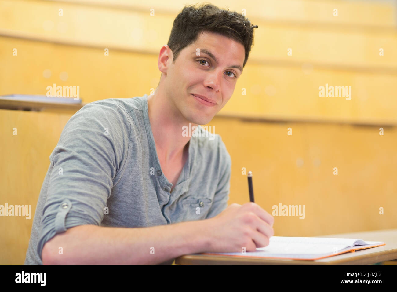 Smiling male student during class Stock Photo - Alamy