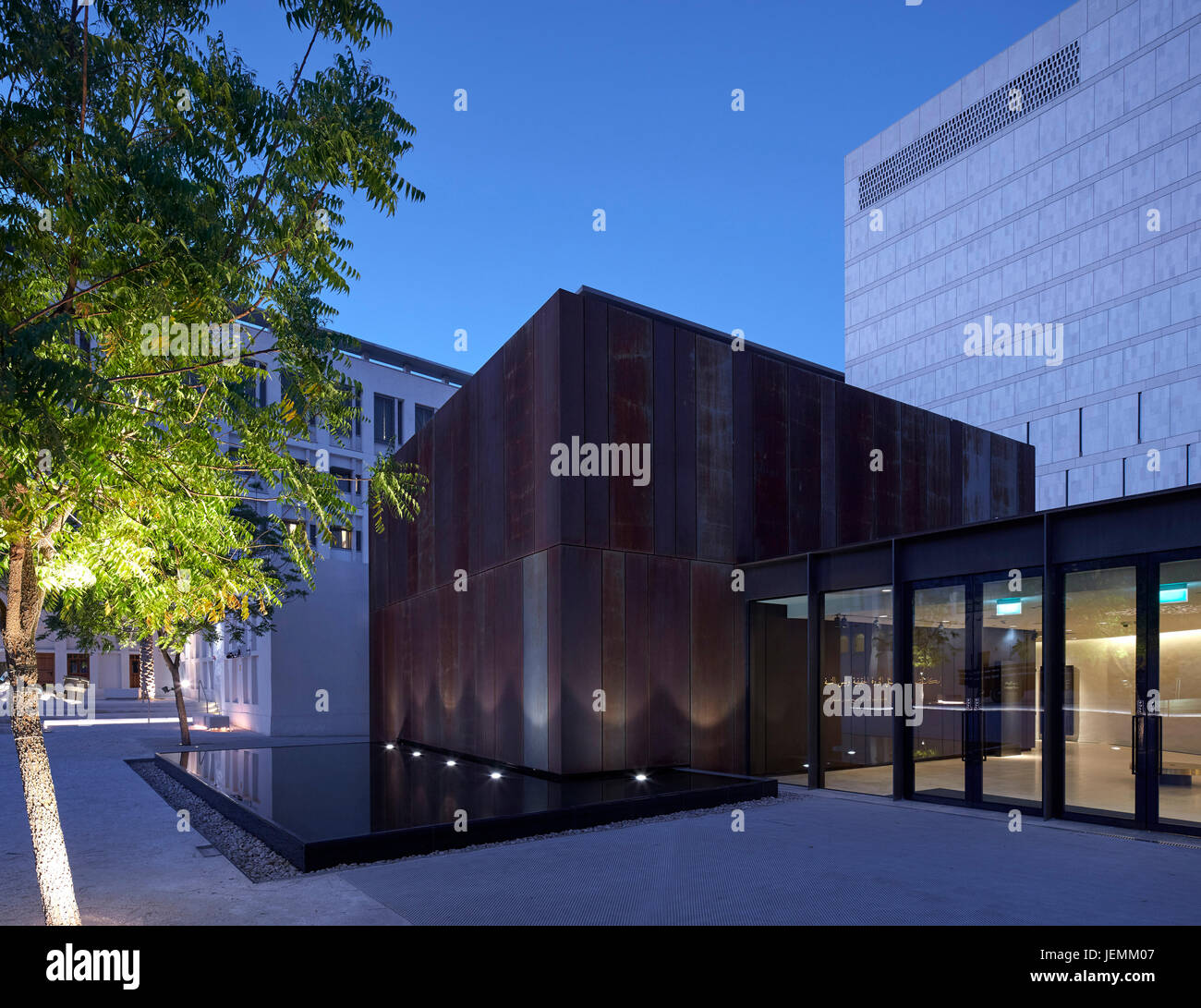 Side view showing Corten steel cube over water feature. Company House ...