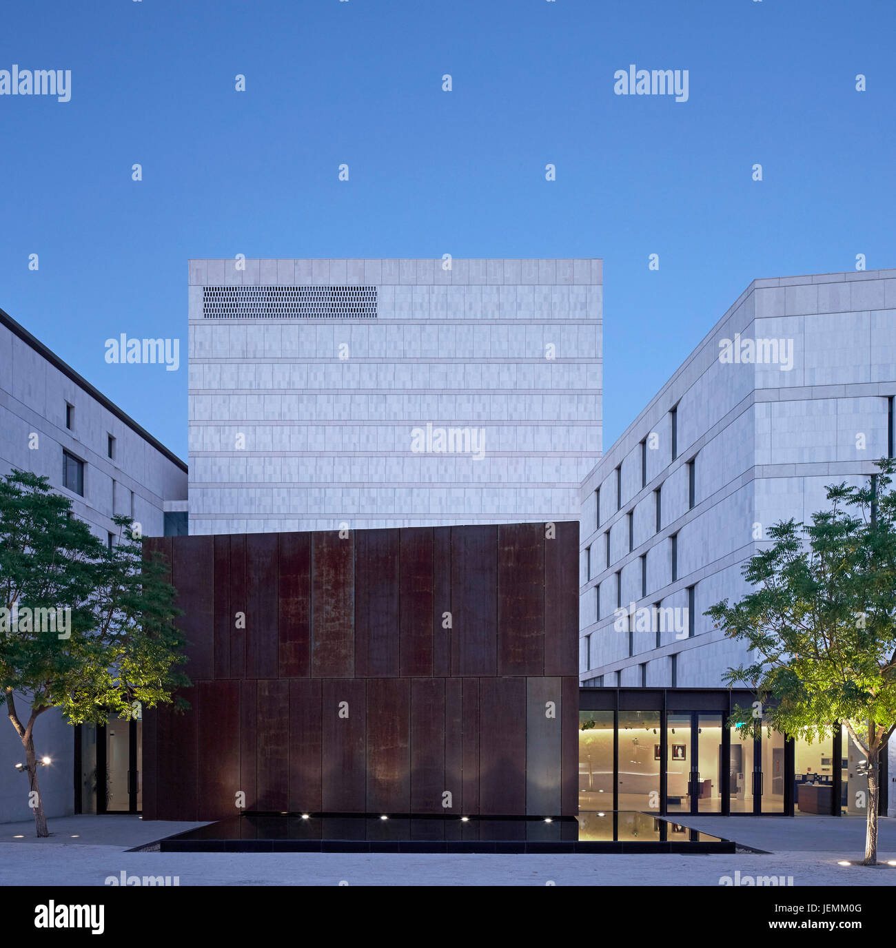 Overall view showing Corten steel cube over water feature. Company ...