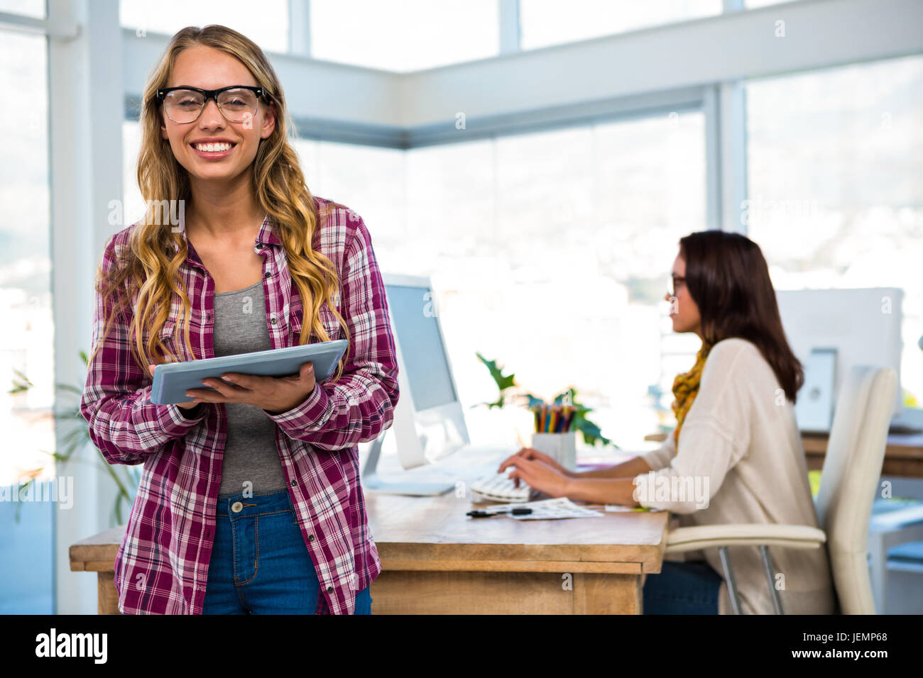 Two girls work at office Stock Photo - Alamy