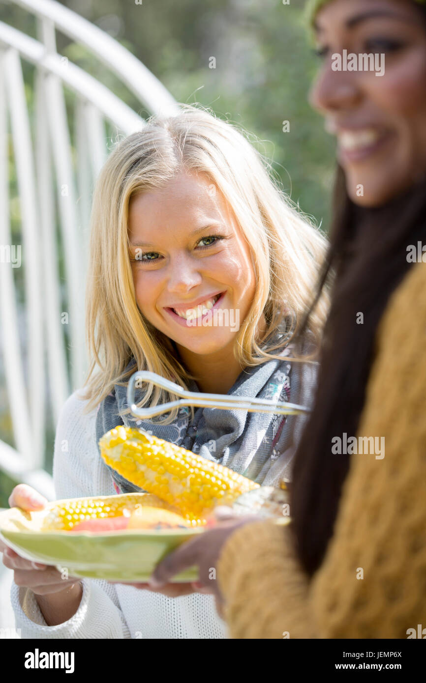 Smiling woman with corn on cob Stock Photo - Alamy