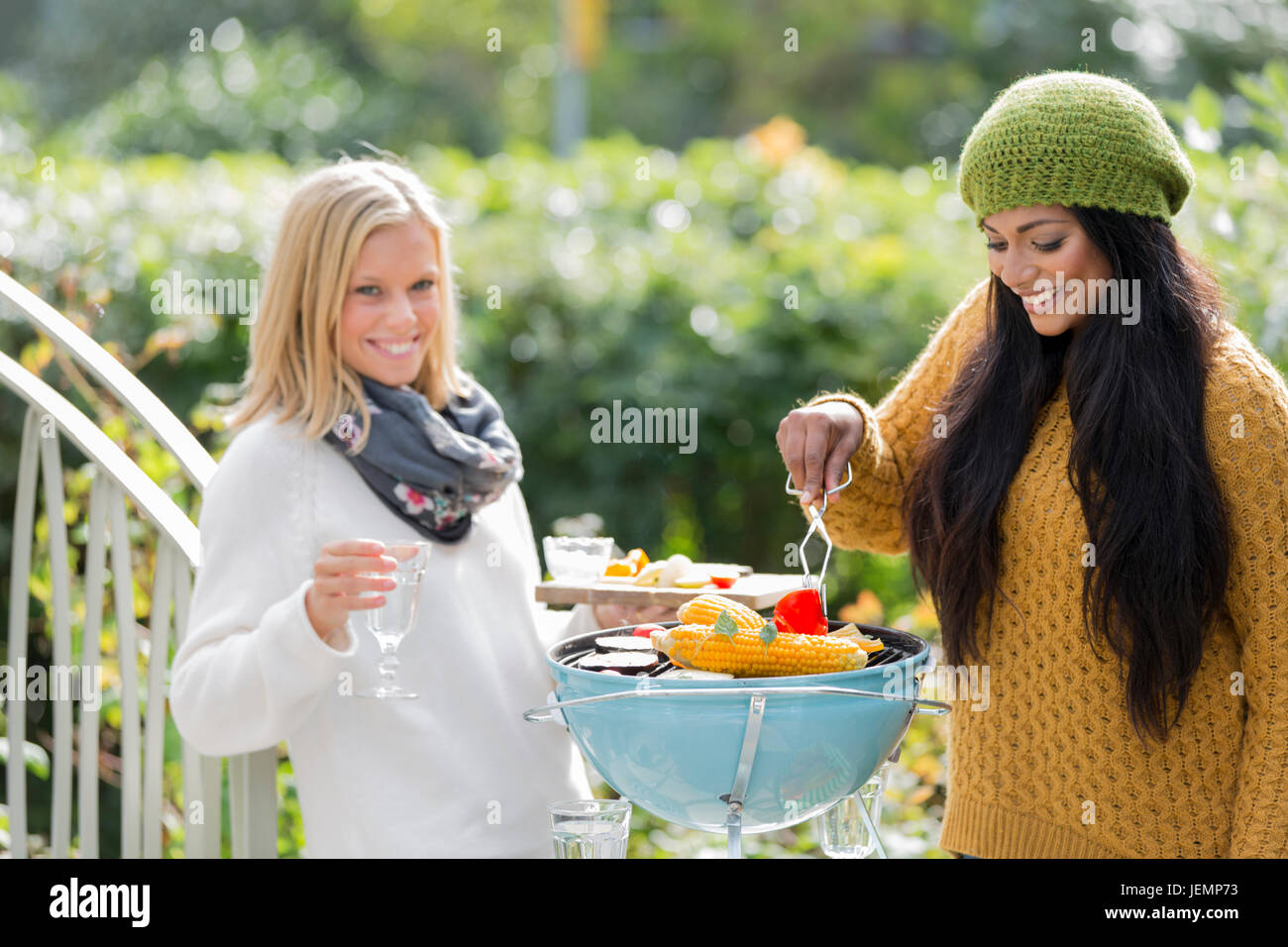 Young women having barbecue in garden Stock Photo - Alamy