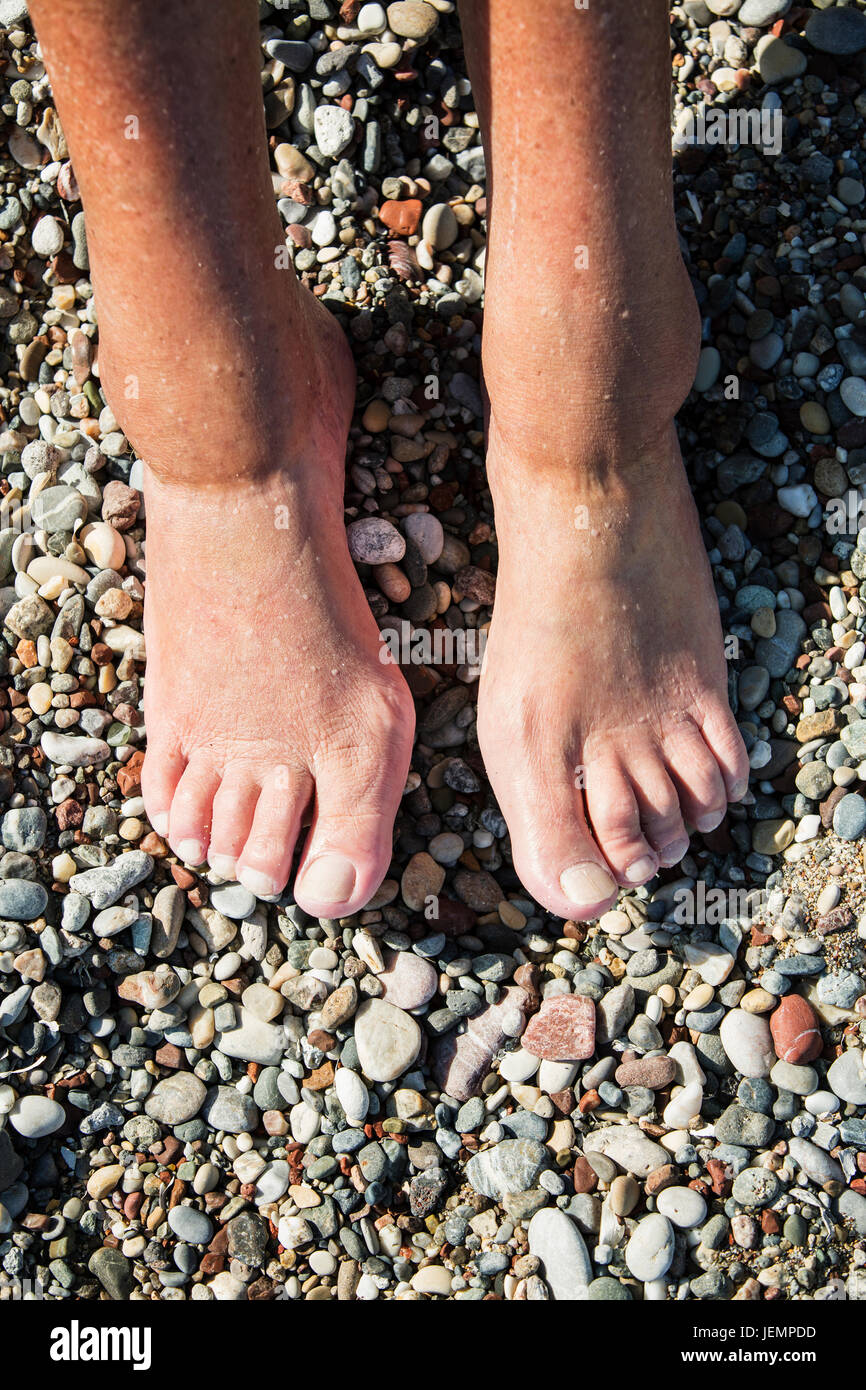 Feet on stones, close-up Stock Photo - Alamy