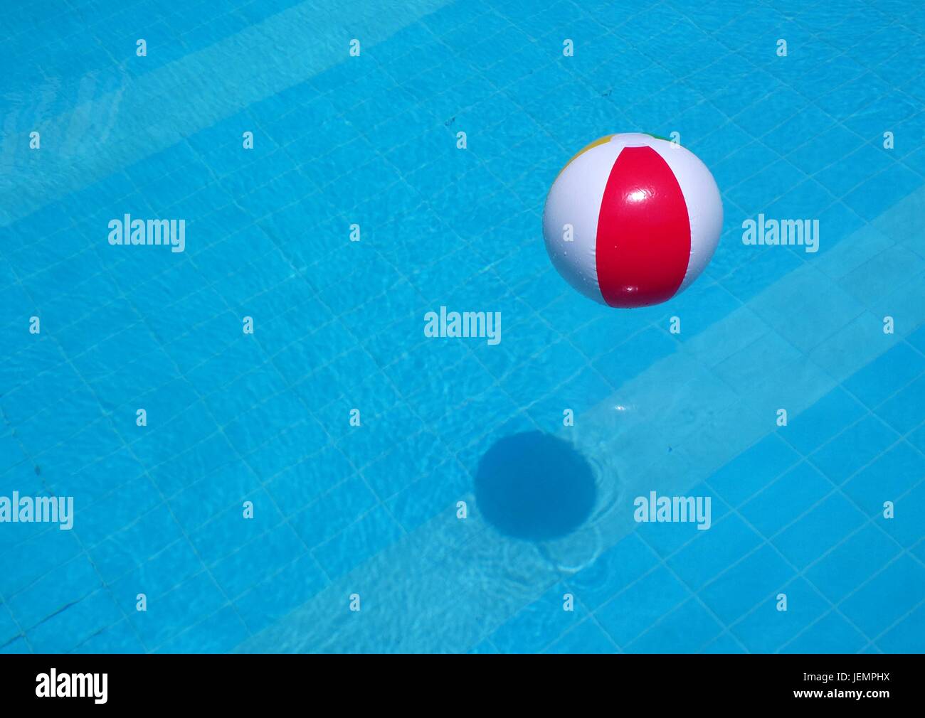 Colorful ball floating on a swimming pool Stock Photo - Alamy