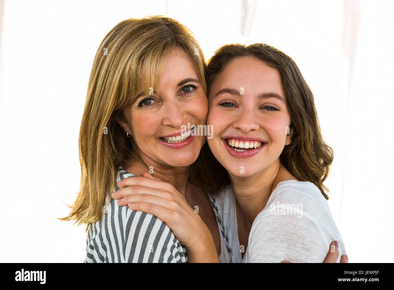 Mother and daughter hugging Stock Photo - Alamy
