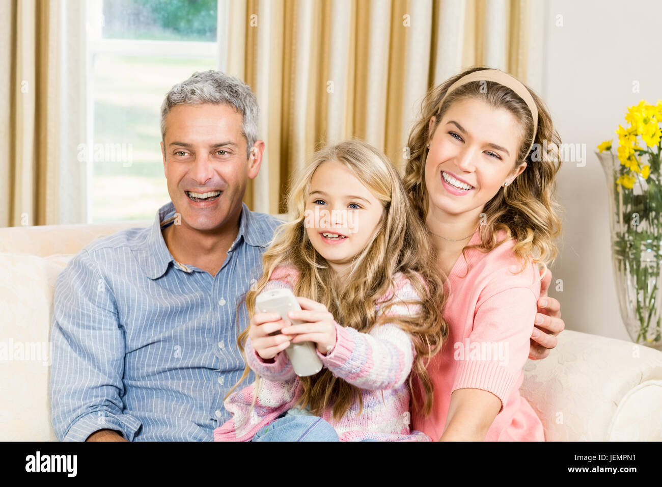 Happy family using remote control Stock Photo - Alamy