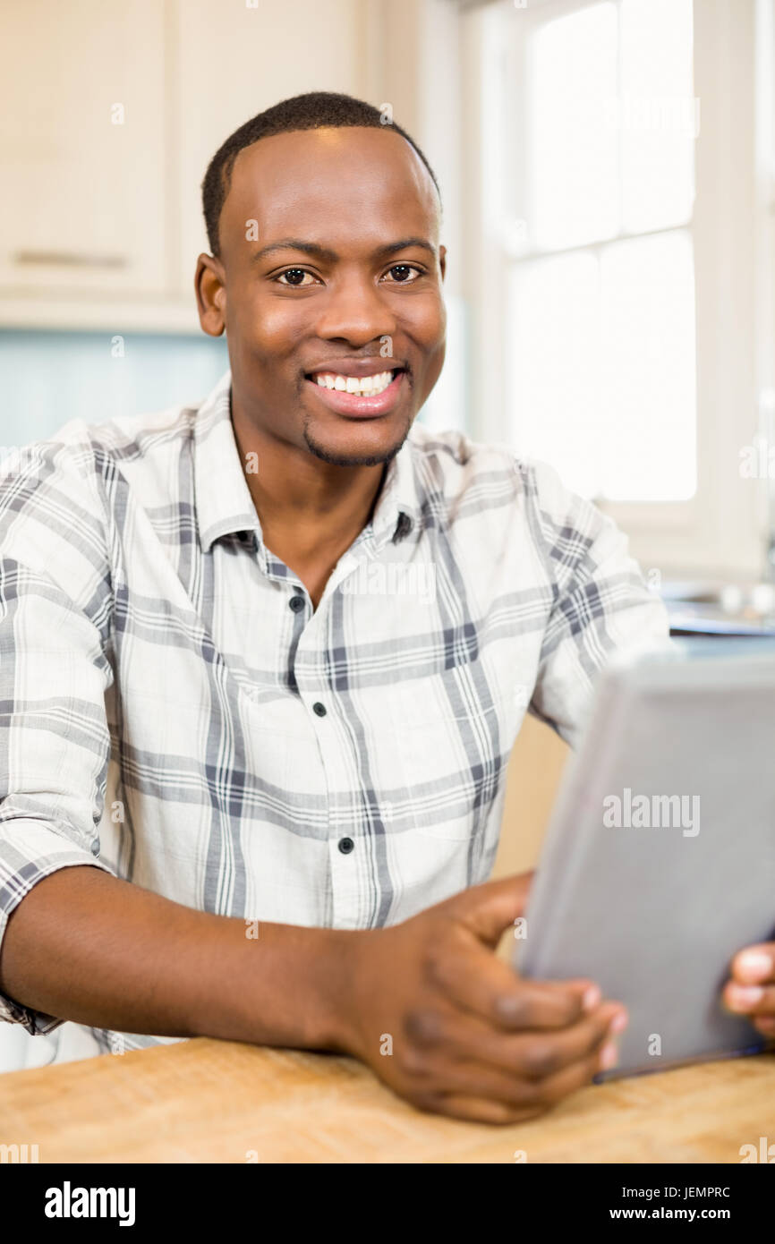 Handsome man using tablet Stock Photo - Alamy