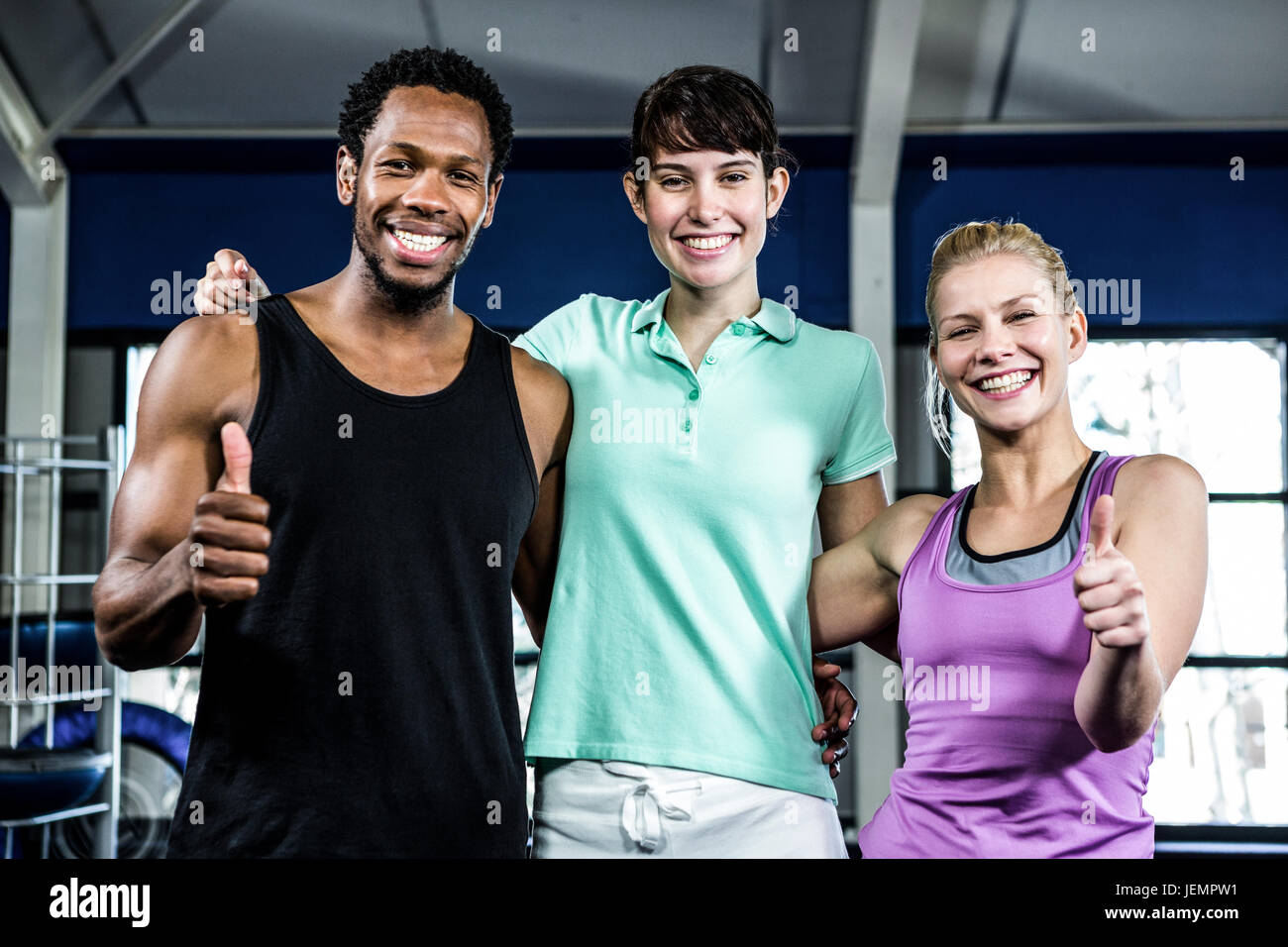 Muscular smiling people standing together Stock Photo - Alamy