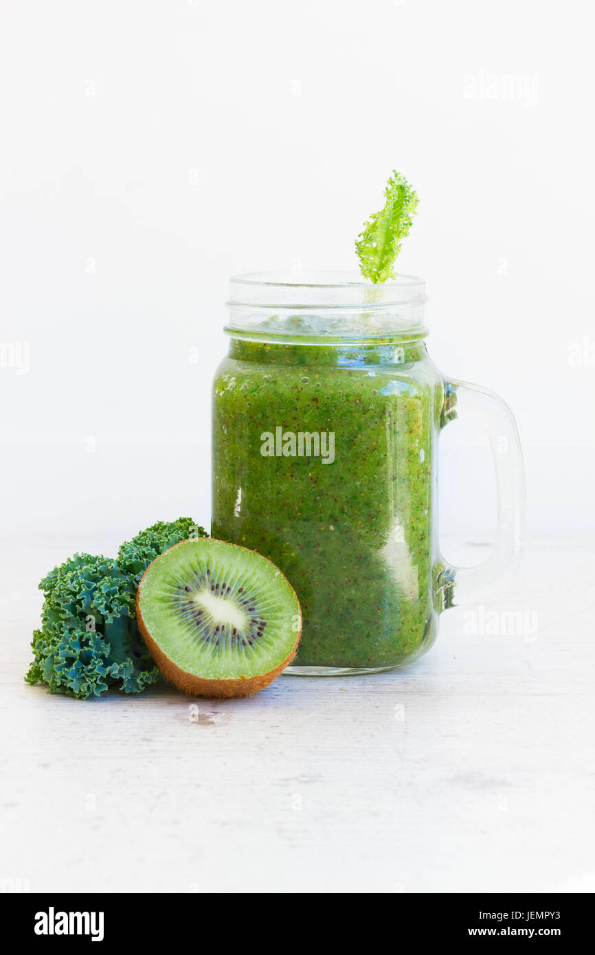 Fresh smoothy green drink in glass jars with igredients on white Stock ...