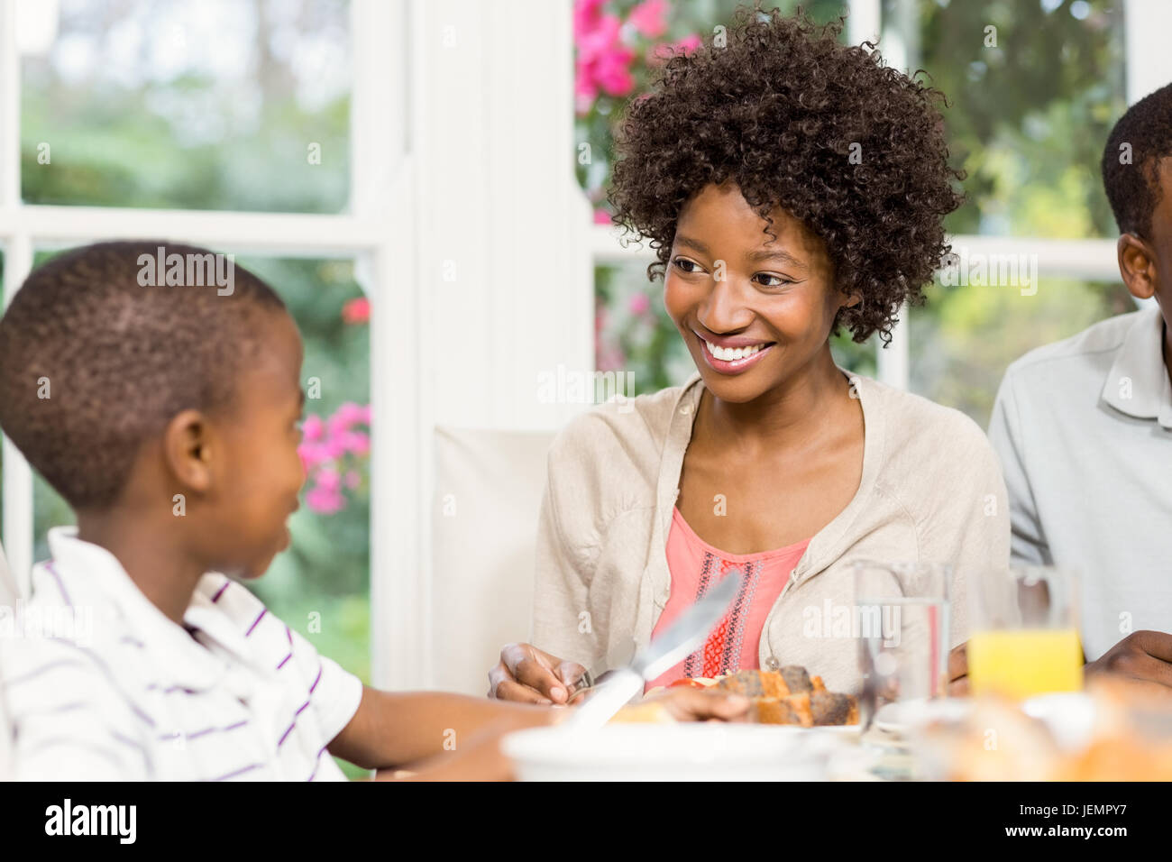 Smiling son eating his dinner Stock Photo - Alamy