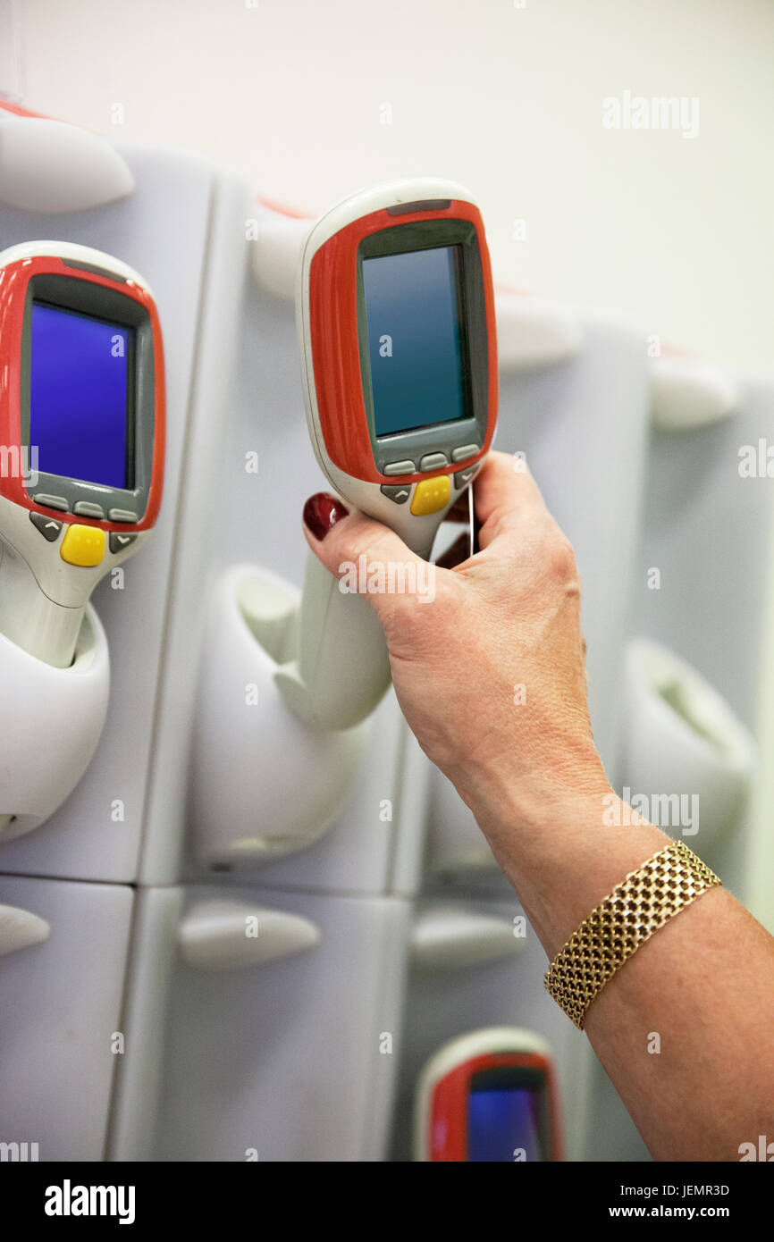 Hand holding barcode reader Stock Photo - Alamy