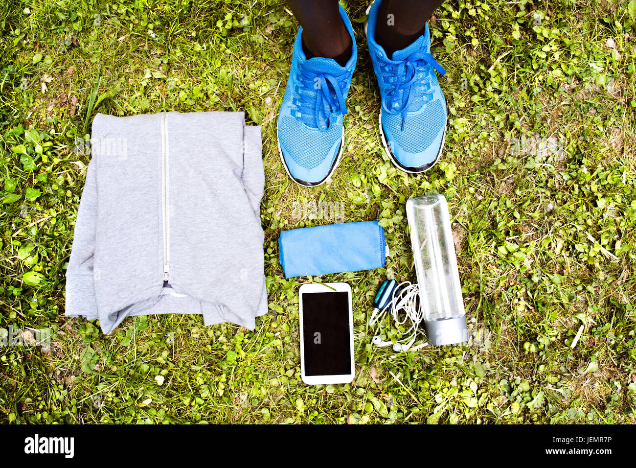 Feet of unrecognizable runner. Sports stuff on grass background Stock ...