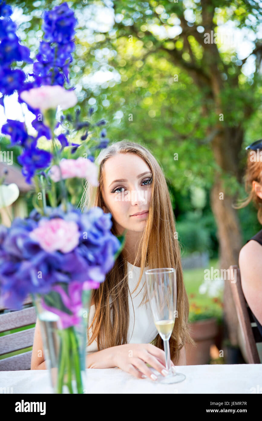 Portrait of teenage girl at table Stock Photo - Alamy