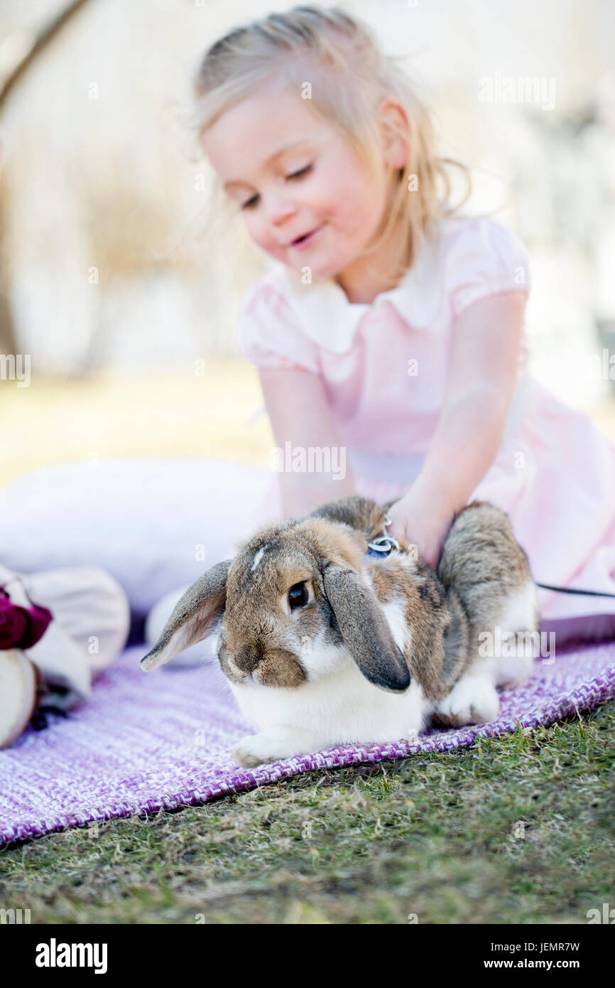 Girl playing with rabbit pet Stock Photo - Alamy