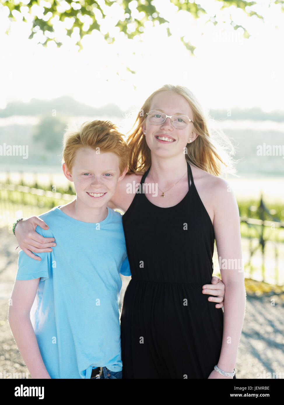Brother and sister standing together Stock Photo - Alamy
