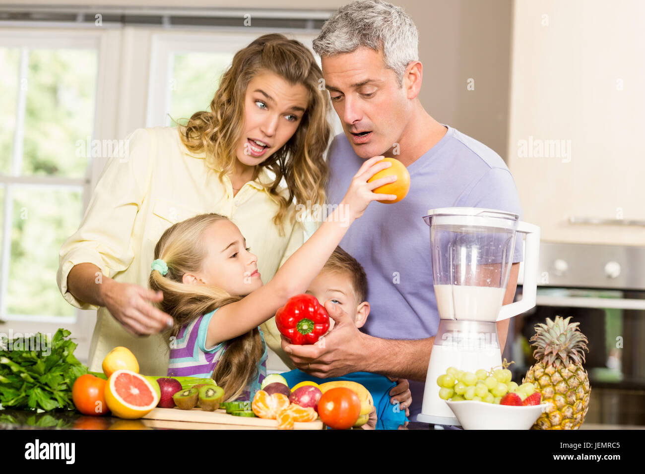 Happy family preparing healthy smoothie Stock Photo - Alamy