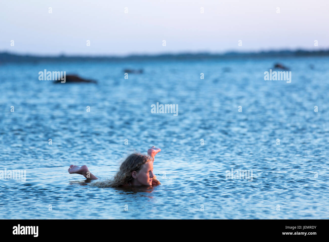 Girl swimming in sea Stock Photo - Alamy