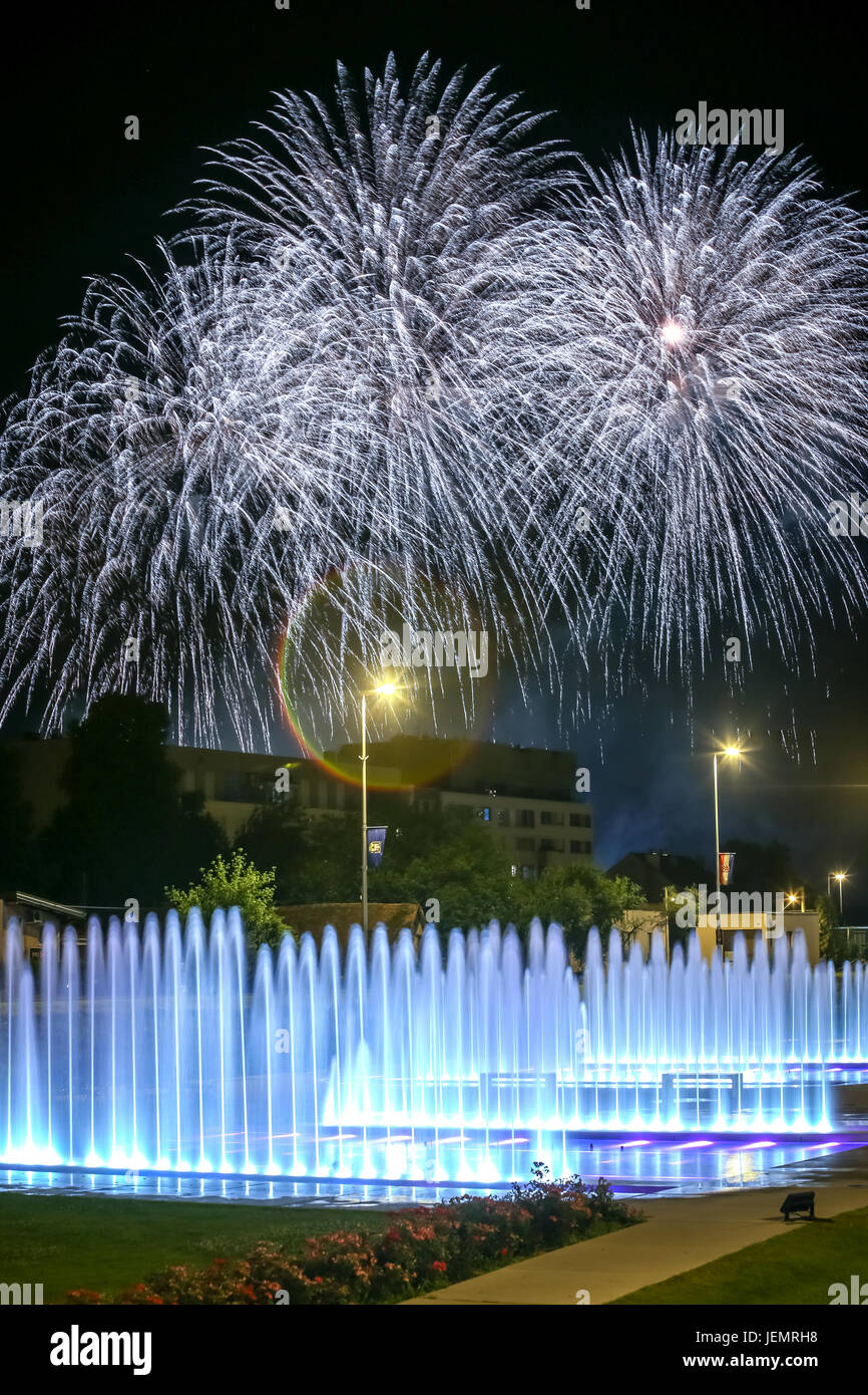 Brightly colorful fireworks above the city water fountains during the ...