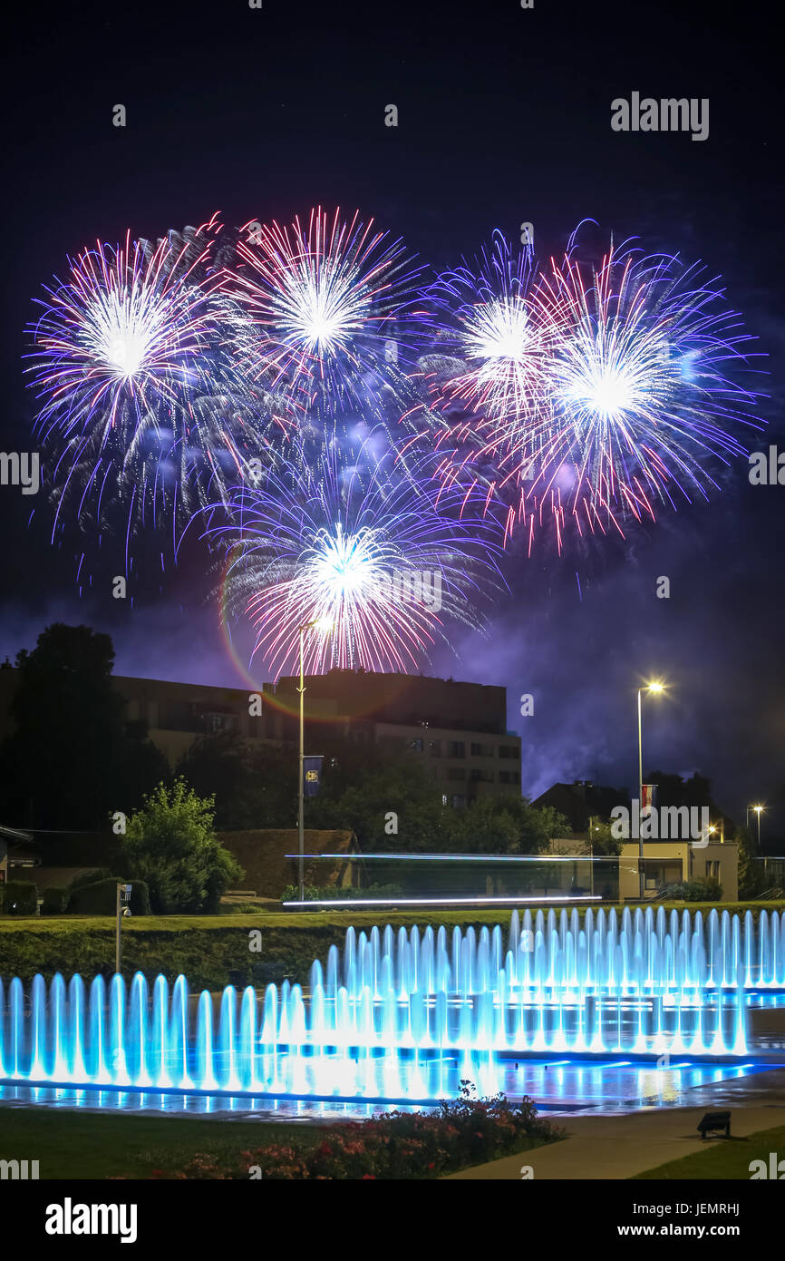 Brightly colorful fireworks above the city water fountains during the ...