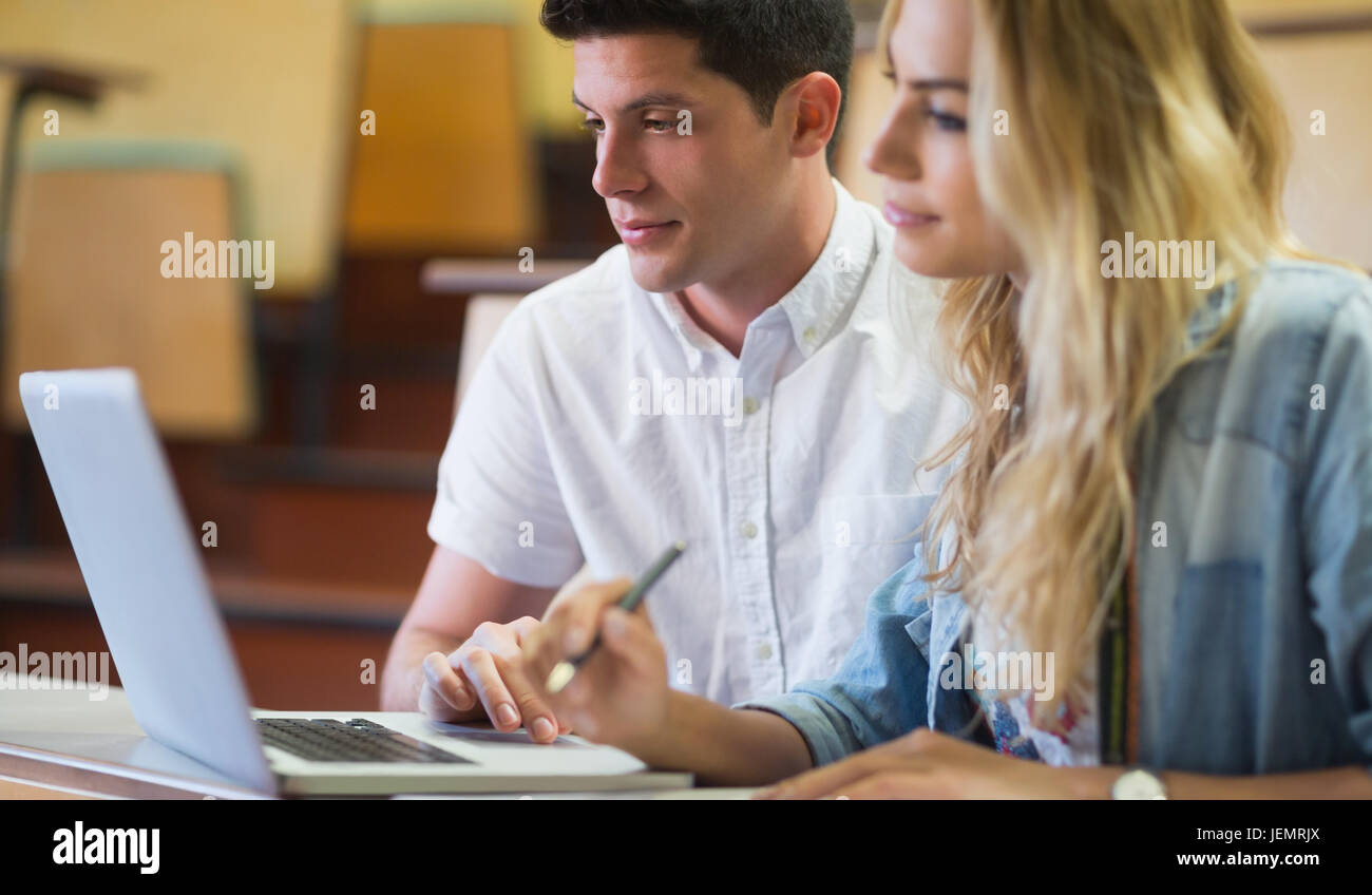 Smiling college students using laptop Stock Photo - Alamy